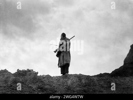 The mountain sheep hunter-Sioux, c1905. Man standing holding a rifle ...
