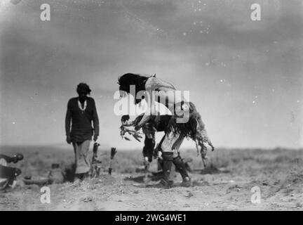 Placing kedan, c1905. Navajo man impersonating Yeibichai, placing ...