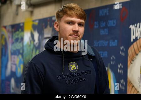 Nolan Tupaea of Warrington Wolves arrives ahead of Toby King's ...