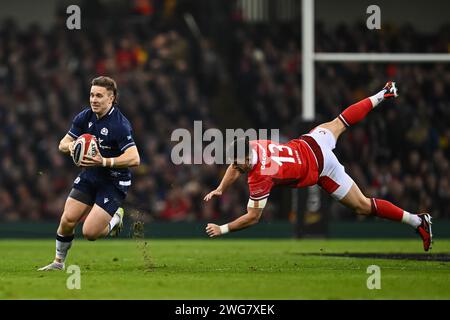 Kyle Rowe of Scotland evades the tackle of Owen Watkin of Wales during ...