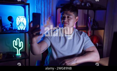 Gamer taking a selfie in gaming room playing online streaming games ...