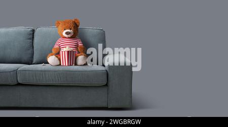 Cute teddy bear watching movies and eating popcorn Stock Photo - Alamy