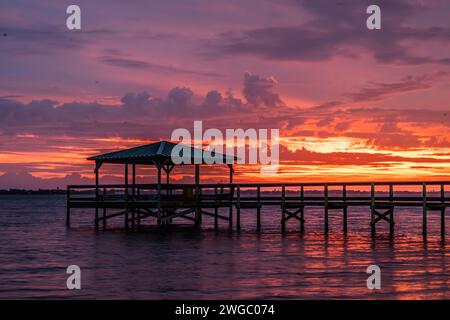 Beautiful red sunrise over dock Stock Photo - Alamy