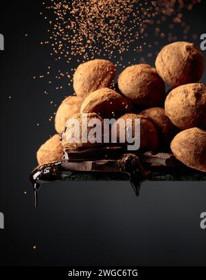 Dessert truffles sprinkled with cocoa on wooden table Stock Photo - Alamy
