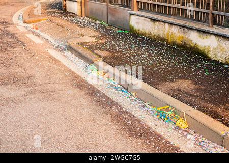 Close up colorful confetti and streamers at the street after Carnival ...