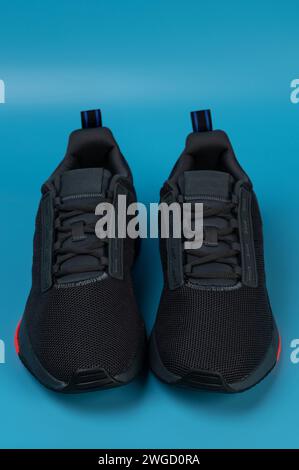 Pair of sport mesh shoes front view isolated on blue studio background ...
