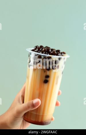 Female Hand Hold Taiwan Boba Pearl Milk Tea with Liquid palm Sugar ...