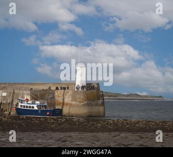 Historic fishing boat and historic white lighthouse in Katwijk ...