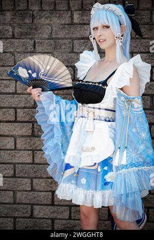 A female cosplayer in a vintage blue dress with blue hair Stock Photo ...