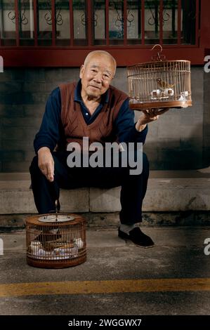 Man Sitting Looking At Bird Cages , Bird Market Stock Photo - Alamy
