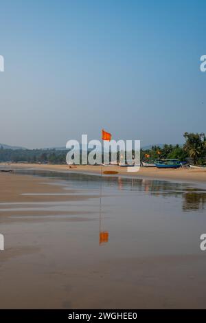 Agonda, Goa, India, Seascape with a peninsula and an orange flag in the ...