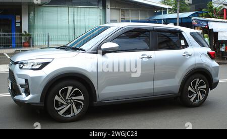 White Toyota Raize car, driving in commercial area, Radio Dalam Street ...