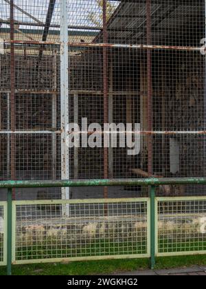 Outdoor fence at the zoo. Empty cages in the zoo. Winter at the zoo ...