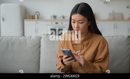 Unhappy asian woman girl disappointed, sad about problem in home alone ...