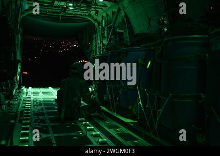 A loadmaster assigned to the 41st Airlift Squadron prepares for a mass ...