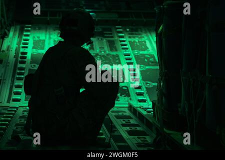 A loadmaster assigned to the 41st Airlift Squadron prepares for a mass ...