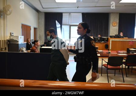 Cesar Santana in court wearing a jailhouse uniform and handcuffs. Cesar ...