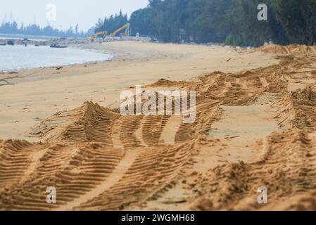 The wheel ruts of construction vehicles on the beach at the seaside ...