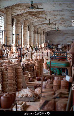 Neatly stacked clay embryos and molds in a traditional Chinese pottery ...