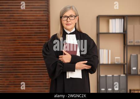 Portrait of judge in court dress with book indoors Stock Photo - Alamy