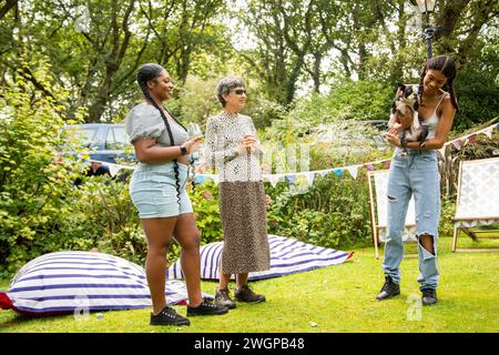 Group of friends enjoy a gathering outdoors. They share laughter and ...