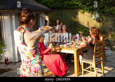 A mixed gathering of women laughing and having fun at a summer garden ...