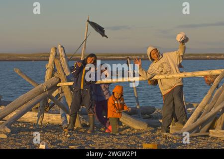 Eskimo Inupiat kids playing at camp on a sandspit along Demarcation bay ...