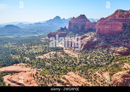 Expansive Sedona landscape with dramatic red rock cliffs under vibrant ...