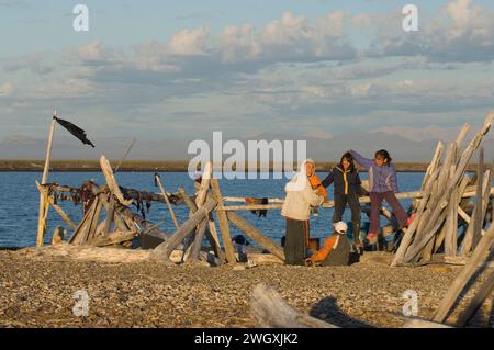 Eskimo Inupiat kids playing at camp on a sandspit along Demarcation bay ...