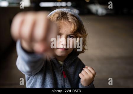Kid boy in hoodie fighting. Little kid boy fighting outside. Angry ...