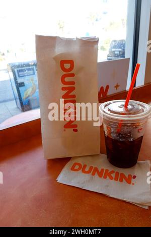 Dunkin' Donuts paper bag and iced coffee inside the shop Stock Photo ...