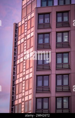 Modern building reflecting the pink and purple colours of the ...