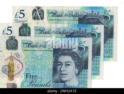 Five pound notes featuring a portrait of Queen Elizabeth II from the ...