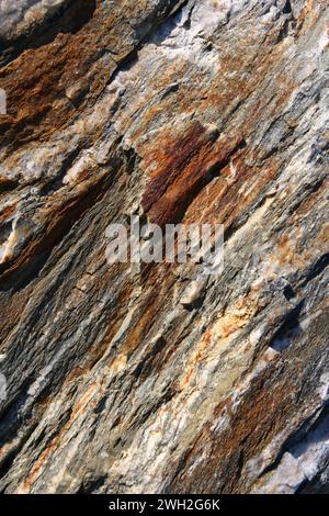 Boulder of metamorphic rock (Schist) in a river bed on the western ...