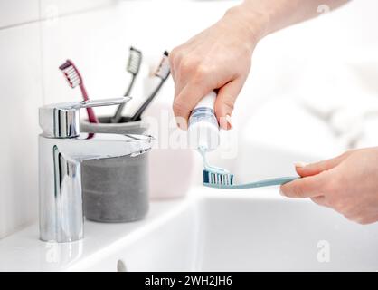 Girl'S Hand Applies Toothpaste On Brush For Hygiene In Pristine White ...