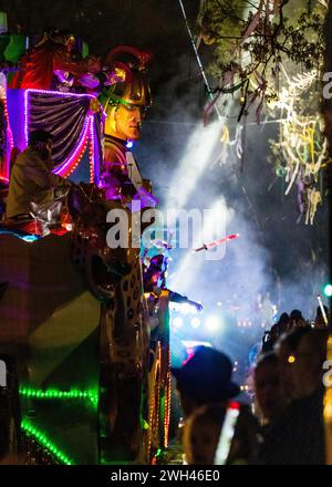 Crew of the Krewe of Bacchus throwing beads, toys, and other swag to ...