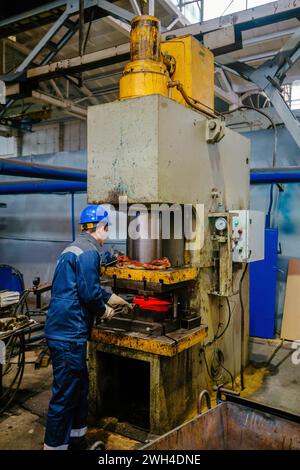 Process of pressing and quenching of hot iron part Stock Photo - Alamy
