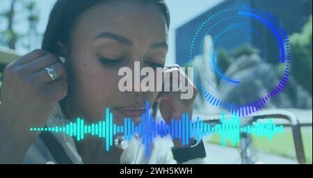 Image of scope scanning and music graphic equalizer over woman using ...