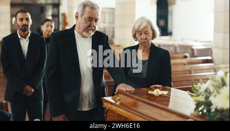 Senior women, hug and funeral in church for comfort, support and care ...