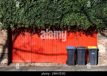 bins in front of a red gate on Gereonswall, waste seperation, Cologne ...