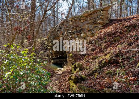 Narrow path going through ancient stone buildings with shabby walls and ...