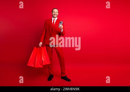 Photo of romantic shopaholic hold bags send air kiss hands cheeks wear ...