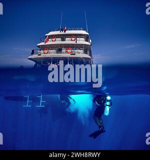 The beauty of the underwater world - diver jumping from boat into water ...