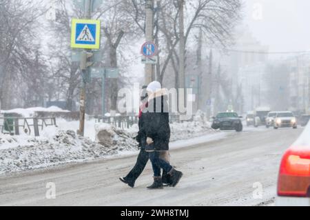 Heavy snowfall in Samara Pedestrians cross an unpaved road during a ...
