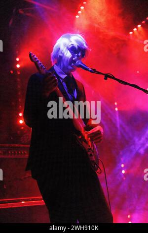 Deb DeMure of gothic rock band Drab Majesty playing guitar live onstage ...