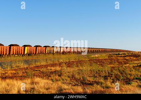 Full iron ore railway carriages and level crossing, Pilbara, Western ...
