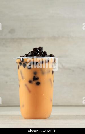 Plastic cup of tasty bubble tea with lemon on white background Stock ...
