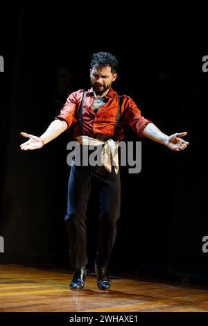 A male flamenco dancer spreads his arms with emotional intensity on a ...