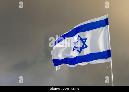 Blue and white Israeli flag waving in the wind with a Mediterranean Sun ...
