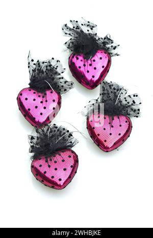 four pink and black hearts on white background Stock Photo - Alamy